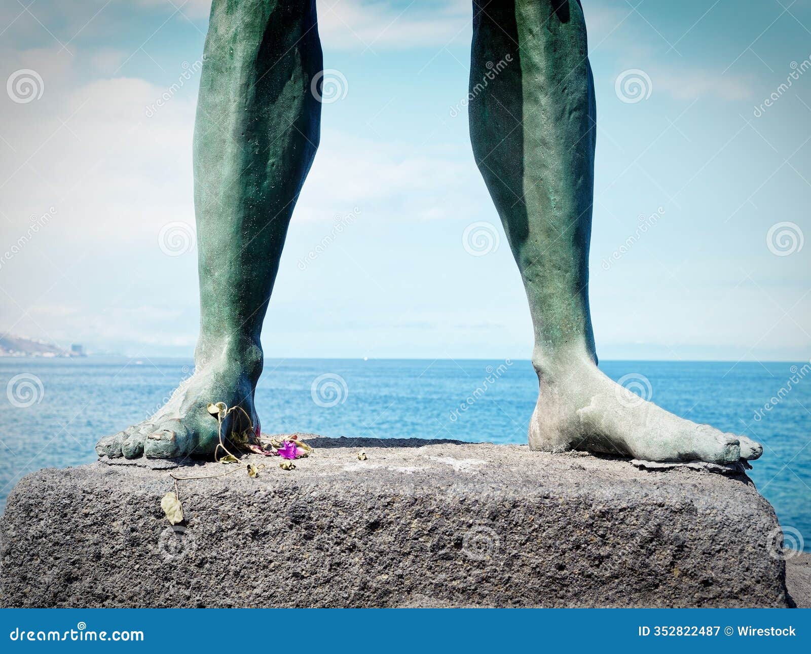 Bare Legs and Feet of a Giant Statue on a Rock, with a View of the ...