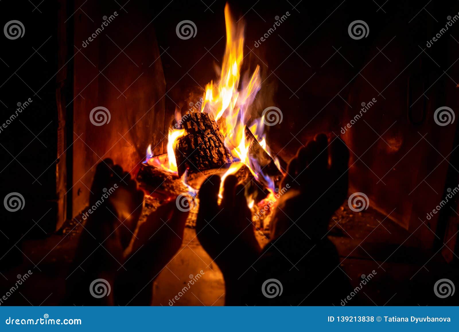 Bare Legs of Young Woman and Man are Heated by Open Fire in Fireplace ...