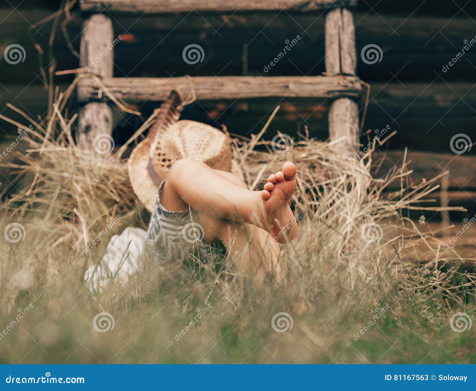 Barefoot Boy Sleeps on the Grass Near Ladder in Haystack Stock Image ... Barefoot Boy Sleeps on the Grass Near Ladder in Haystack Stock Image ...
