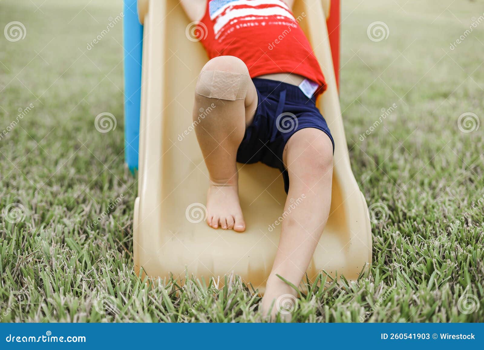 Barefoot child on a slide stock image. Image of playground - 260541903