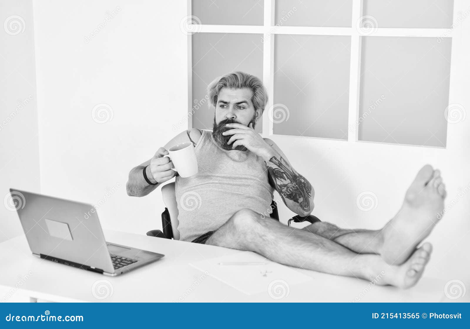 Barefoot Guy Working from Home. Man Working on Laptop at Home ...