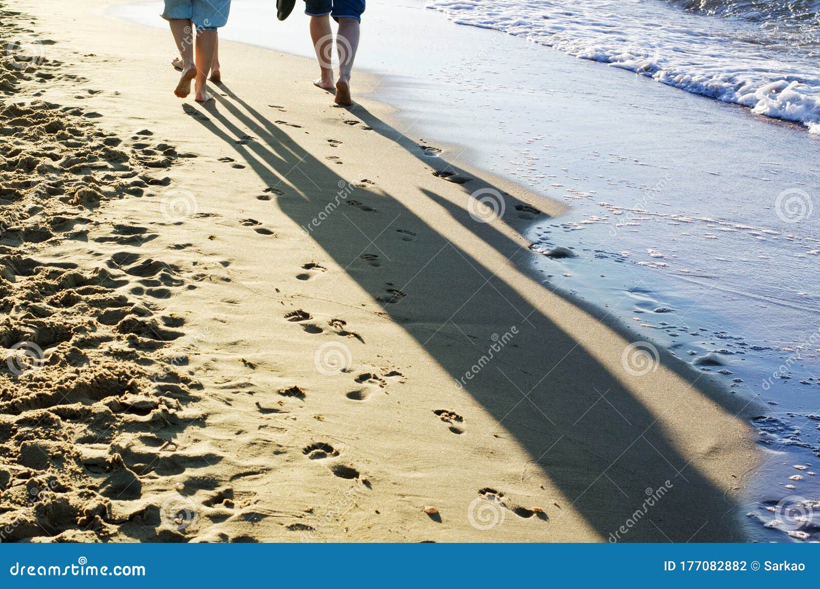 Barefoot people on a beach stock photo. Image of sand - 177082882
