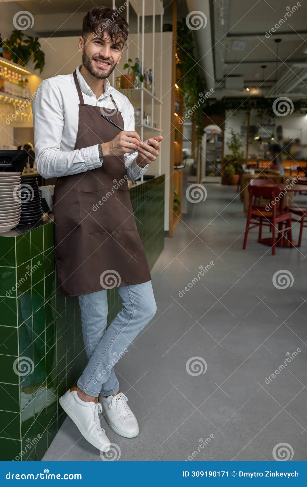 Barista with Beard Standing in Bar Counter and Using Organizer for ...