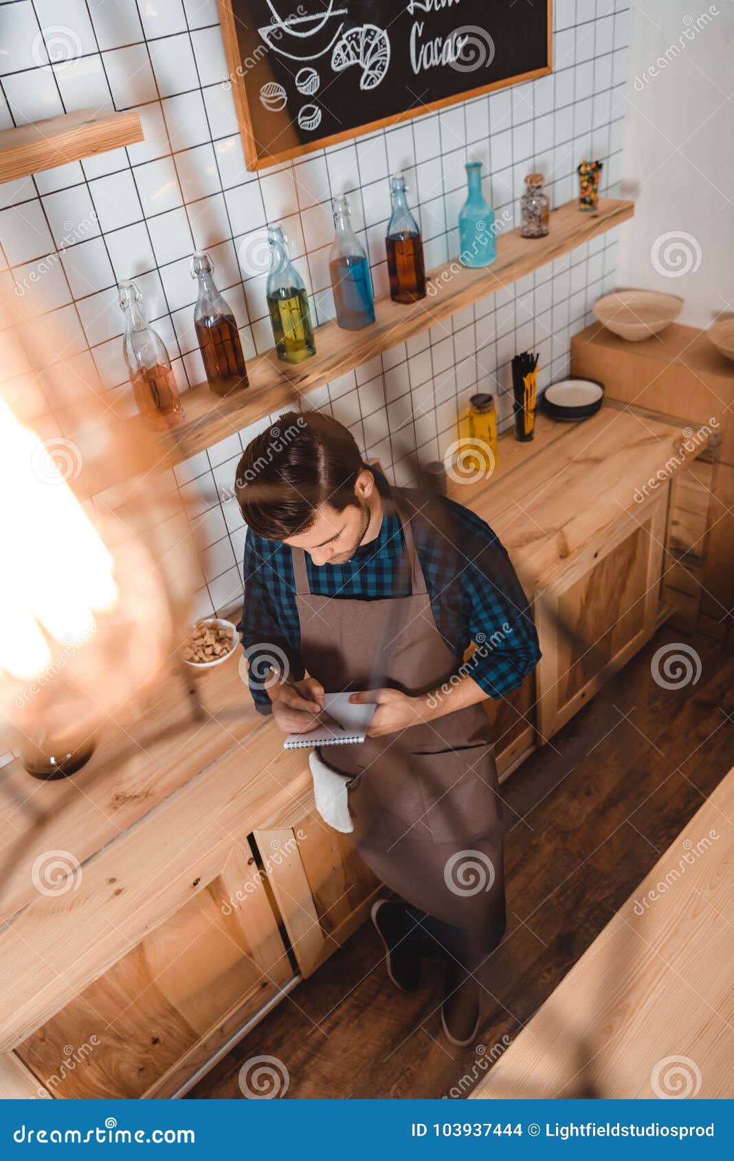 Barista Making Notes in Notebook Stock Photo - Image of alone, counter ...