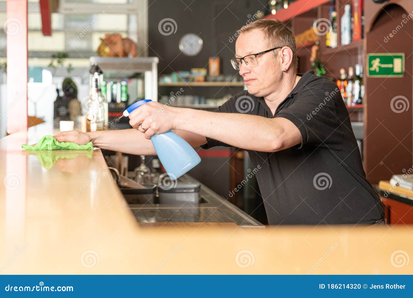 Barkeeper Cleans His Counter with Disinfectant and Rag Stock Photo ...