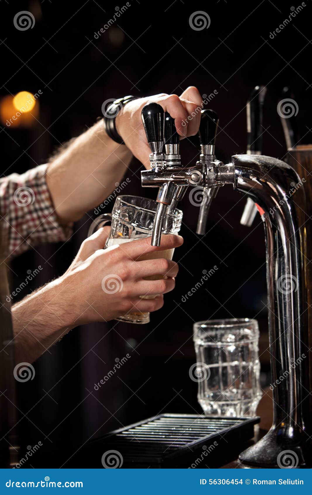 Barkeeper Pulling a Pint of Beer Behind the Bar Stock Photo - Image of ...