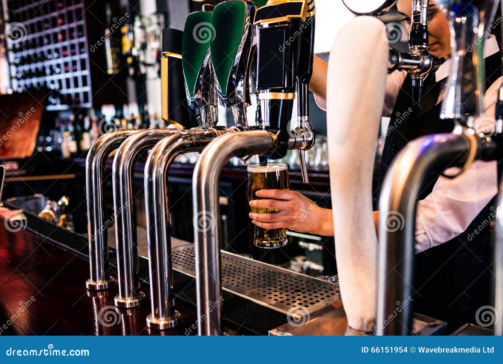 Barmaid serving a pint stock photo. Image of nightclub - 66151954