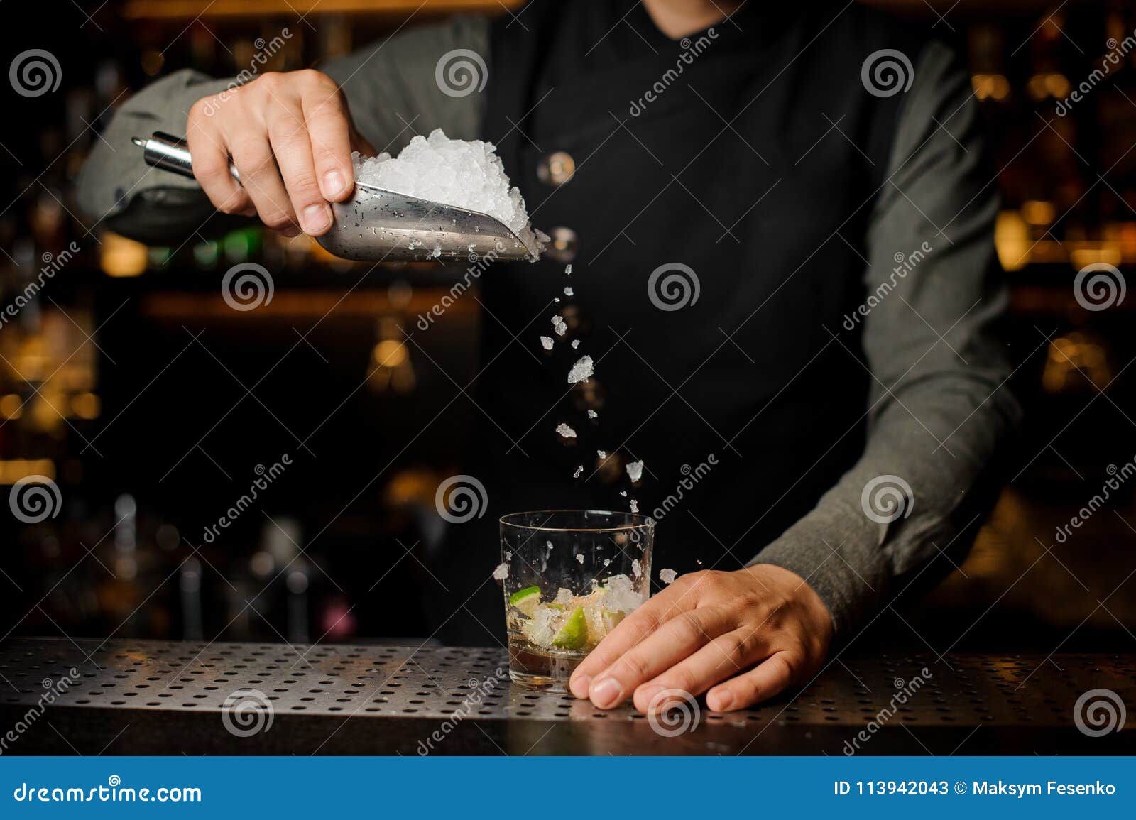 Barman Adding Ice into the Glass with a Cane Sugar and Lime Stock Image ...