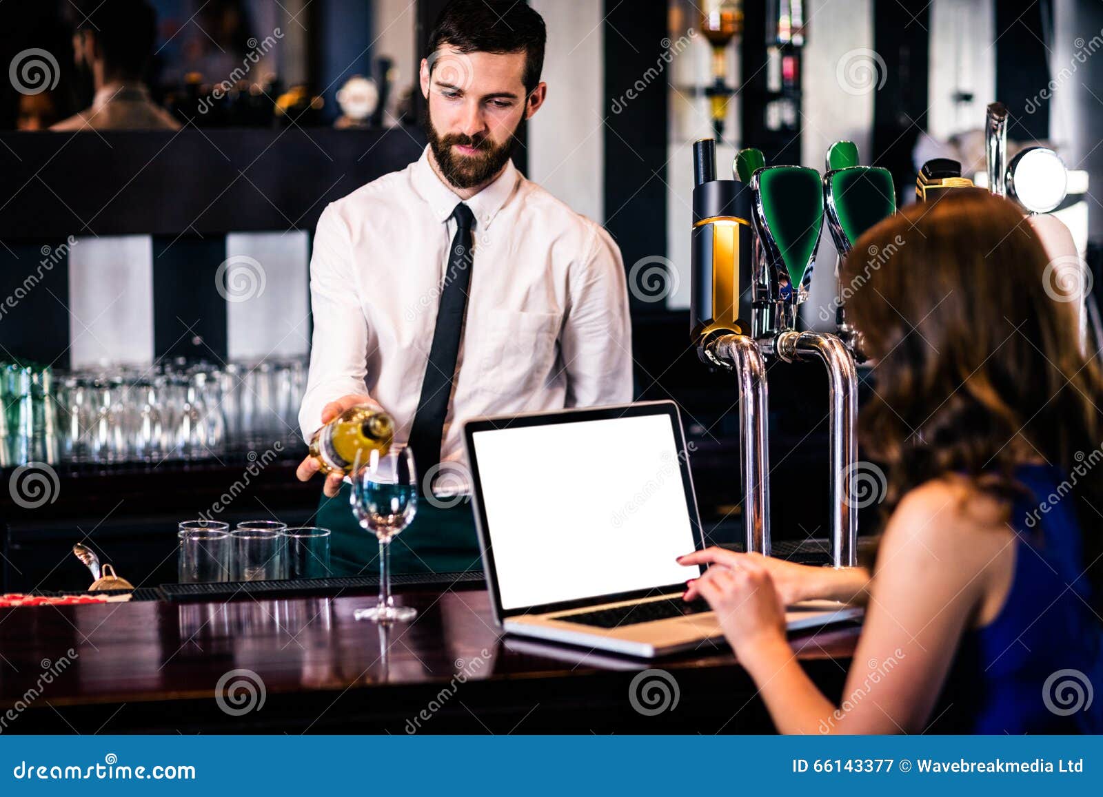 Barman Giving a Drink To Customer Using Laptop Stock Image - Image of ...