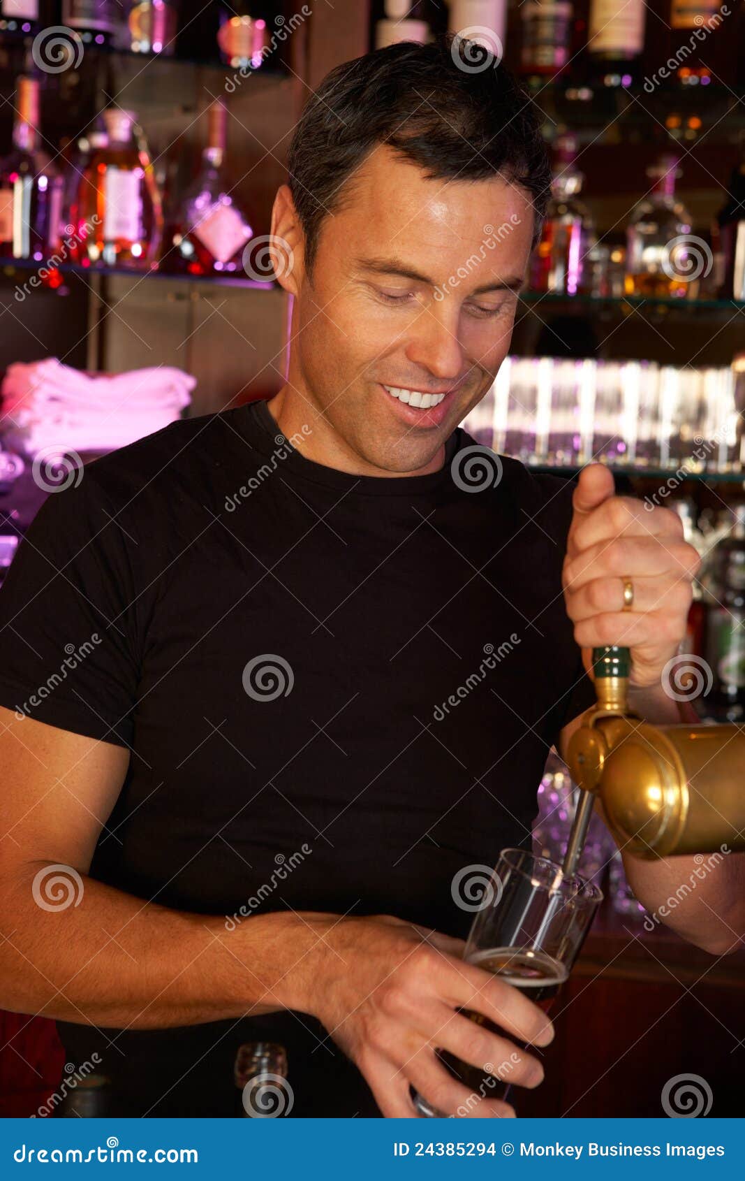 Barman Standing Behind Bar Pouring Beer Stock Photo - Image of ...