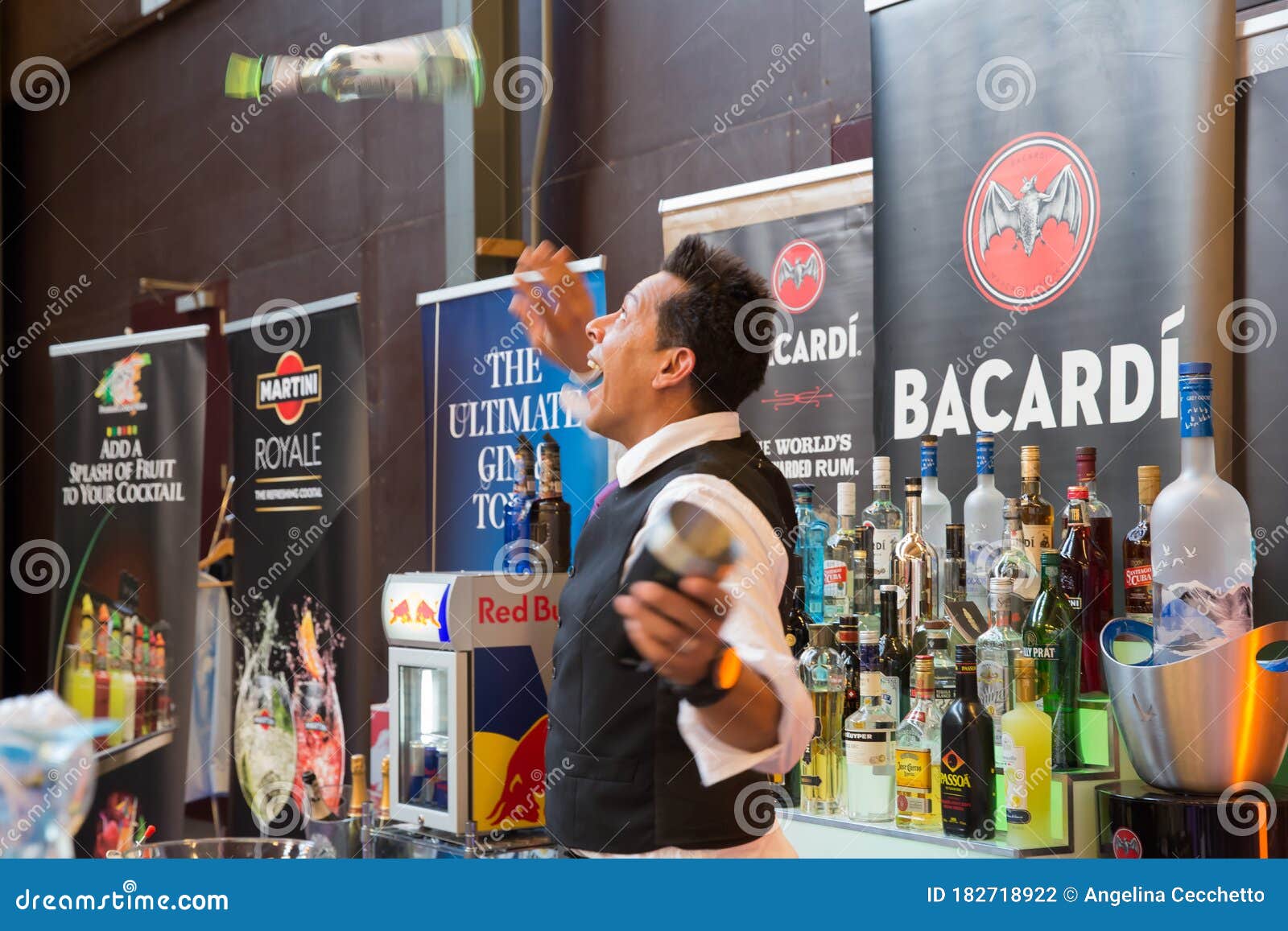 Barman Throwing Alcohol Bottle in the Air Making Cocktail Editorial ...