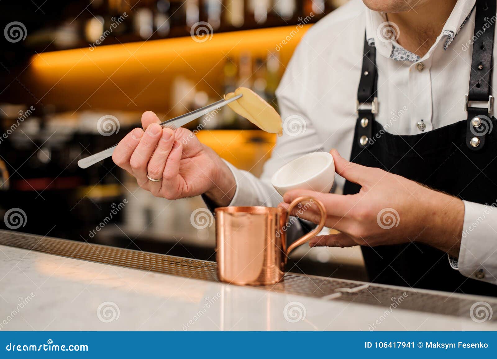 Barman in White Shirt Adding Two Slices of Ginger into a Cup Stock ...
