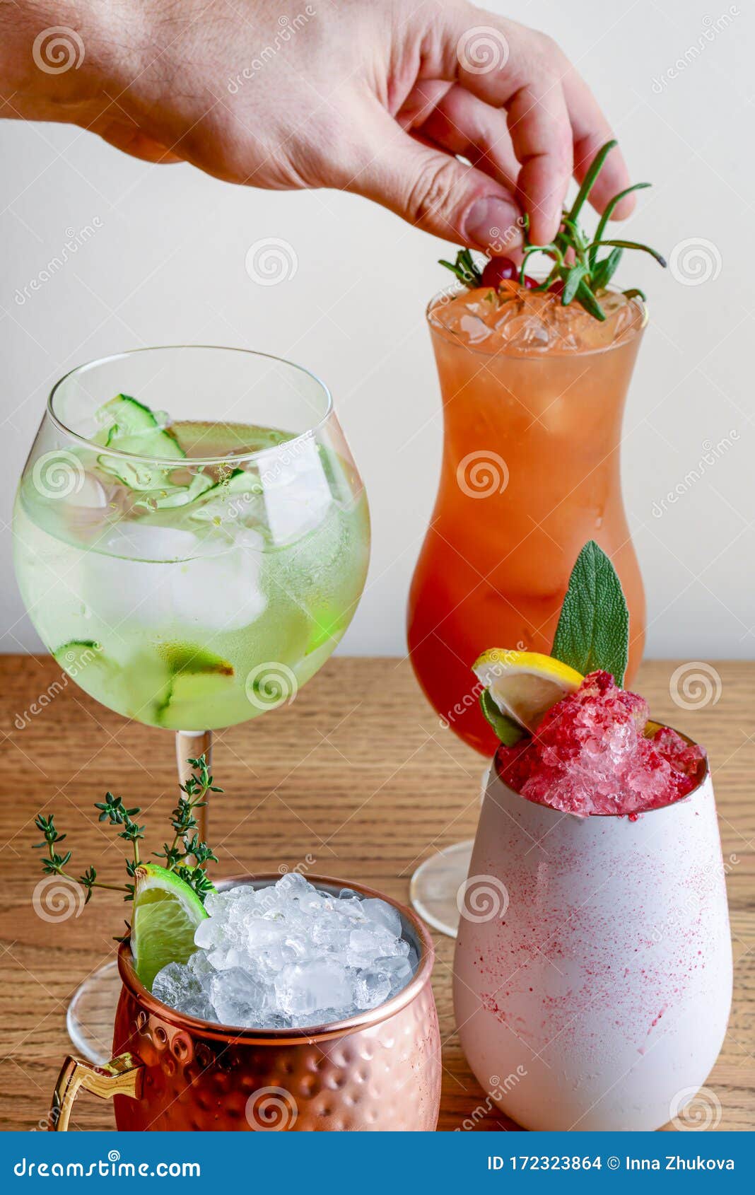 Barmans Hans Decorating Four Different Assorted Cocktail Drinks Made ...