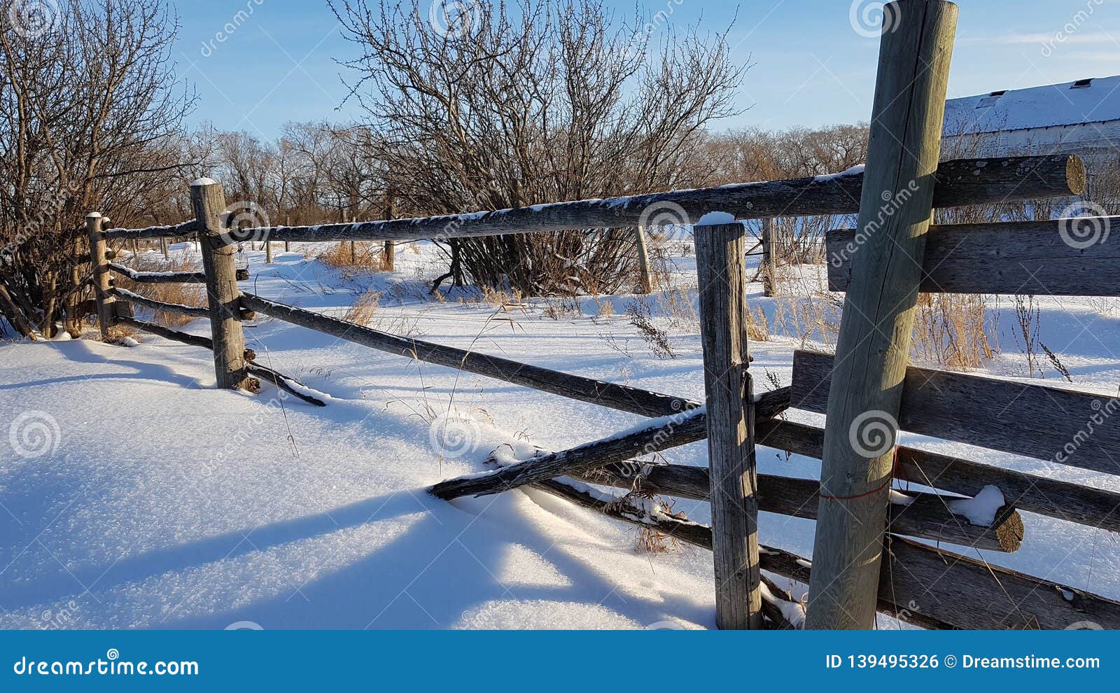 Old Barn With Fence Made From Old Steel Wheels Royalty-Free Stock ...