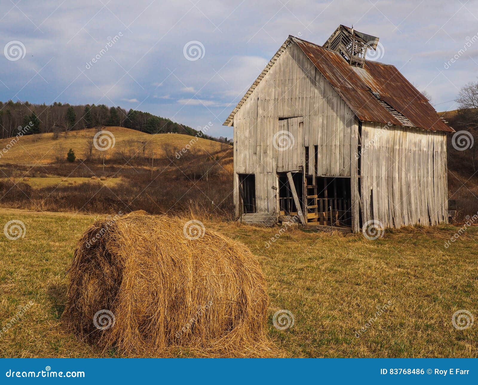 Barn and Hay Roll stock photo. Image of meadow, rustic - 83768486