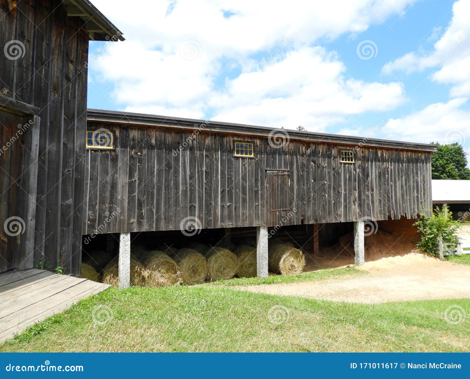 Wood Barn with Round Hay Bale Storage Below Stock Image - Image of ...