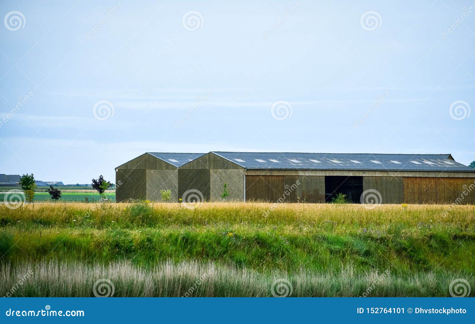 Barn or Warehouse between Meadows, and Farmland. Blue Sky for Text ...