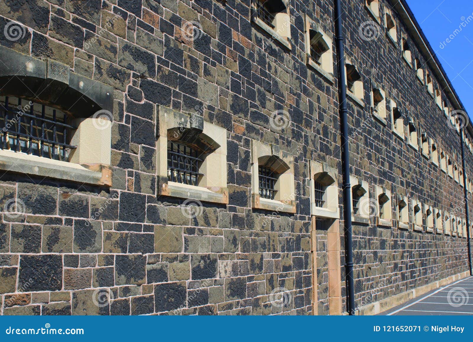Barred Windows on Wall of Prison Stock Image - Image of jail, stone ...