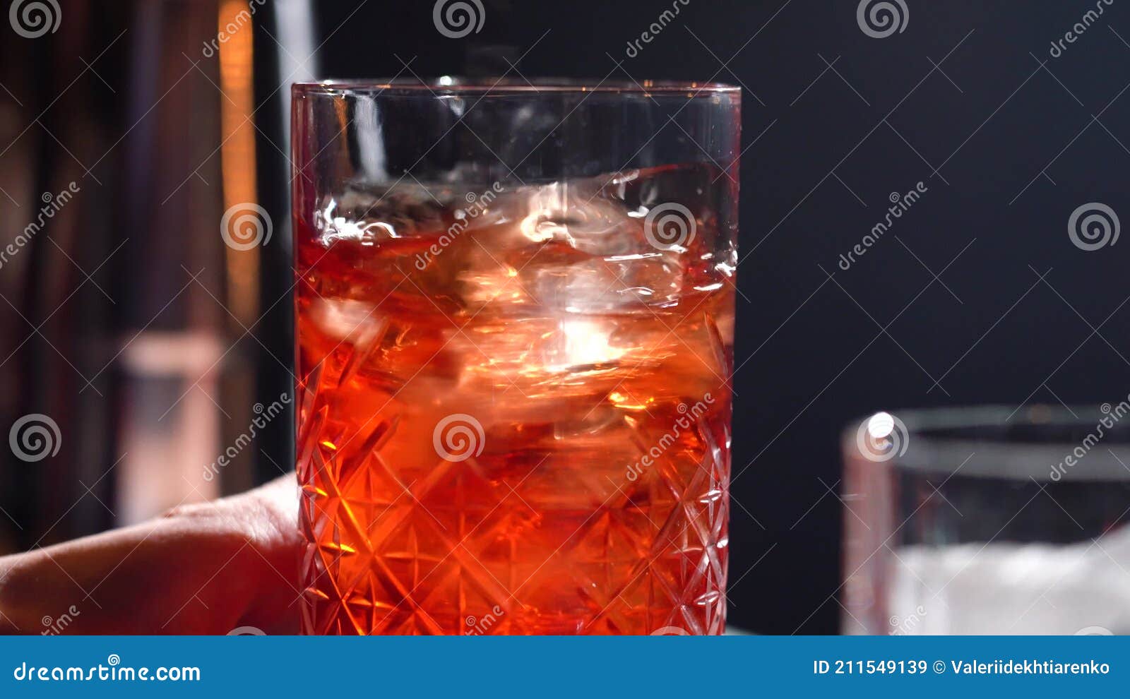 Bartender Adding Ice Cubes and Stirring in Cocktail Glass Making ...