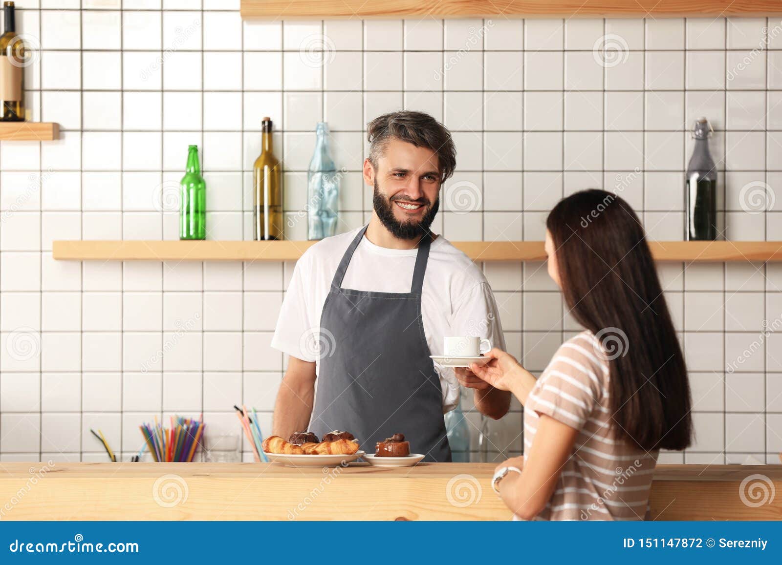 Bartender Giving Cup of Coffee To Female Client in Bar Stock Photo ...