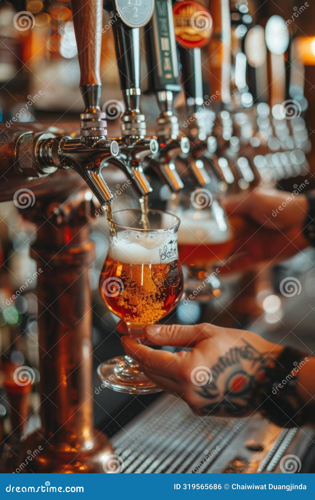 Bartender Hand at Beer Tap Pouring a Draught Beer in Glass Serving in a ...
