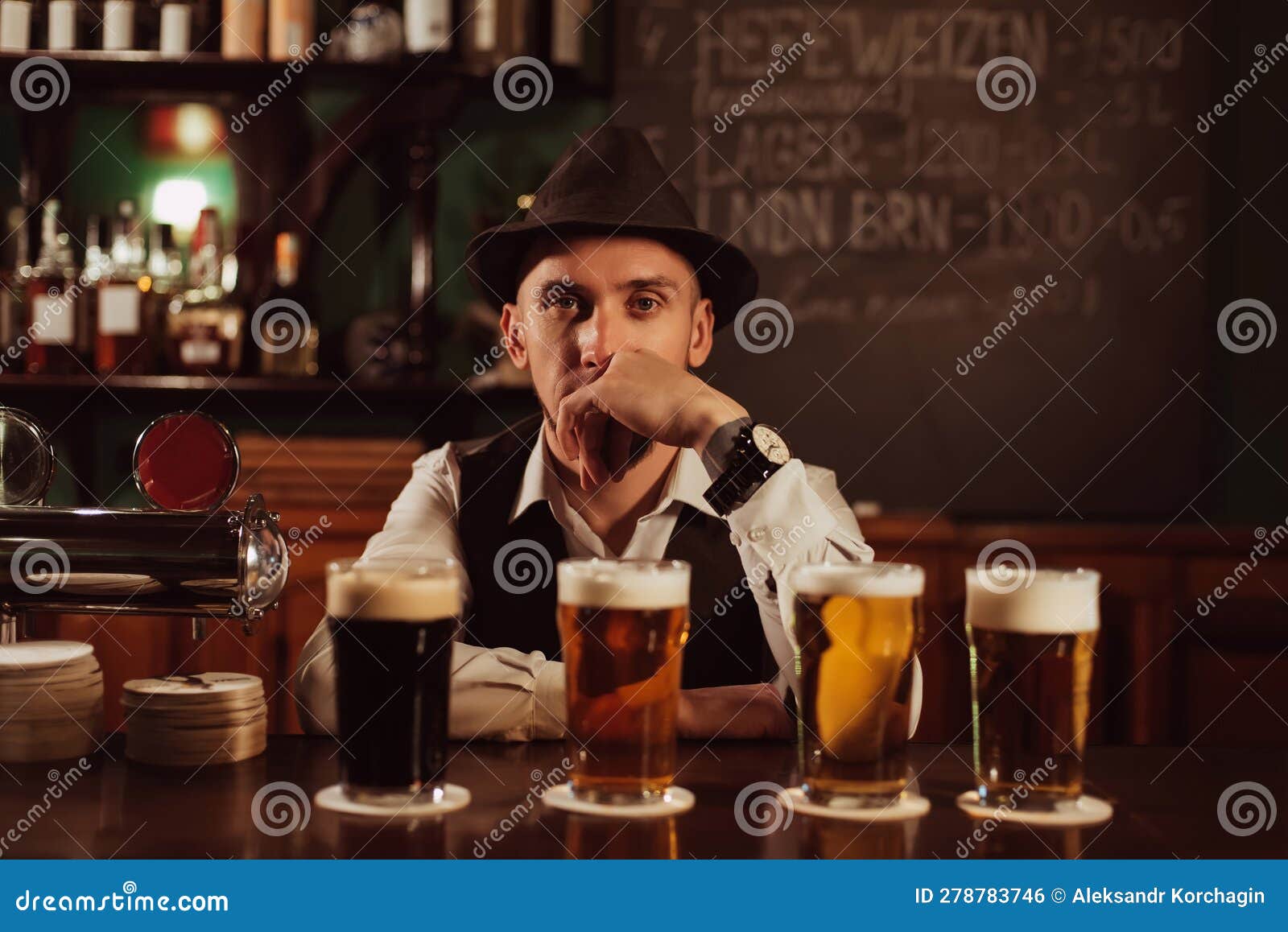Bartender in Hat with a Beard at Bar Counter with Beer in Glasses Stock ...