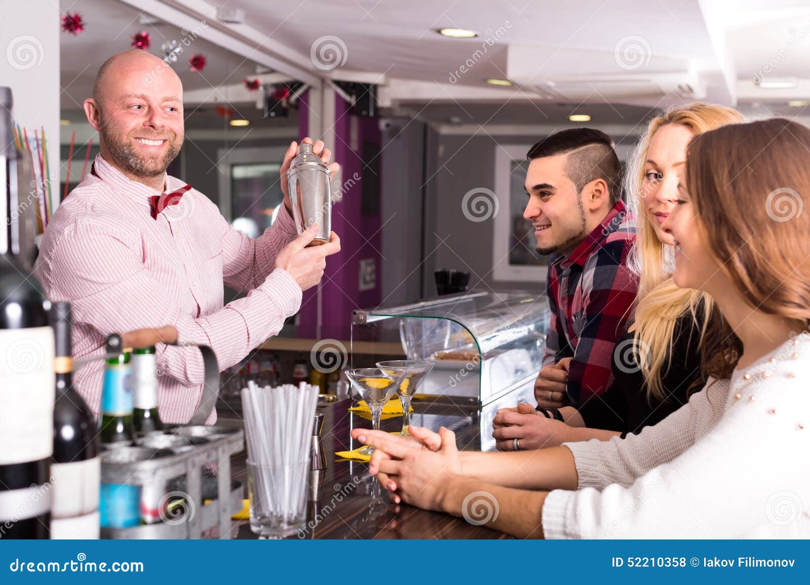 Bartender mixing cocktails stock photo. Image of indoors - 52210358