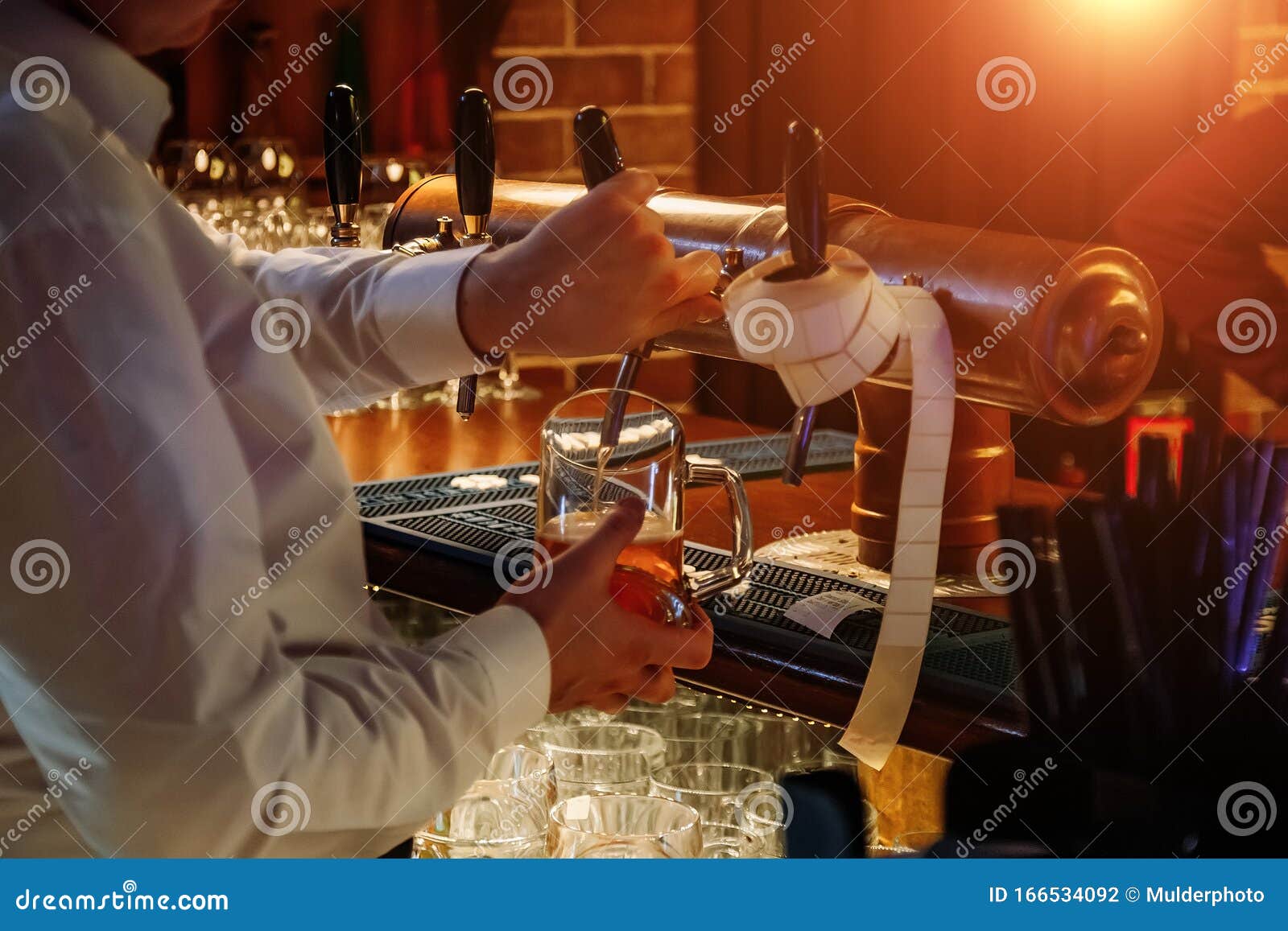 Bartender Pouring Draft Beer from the Crane into the Glass in Pub Stock ...