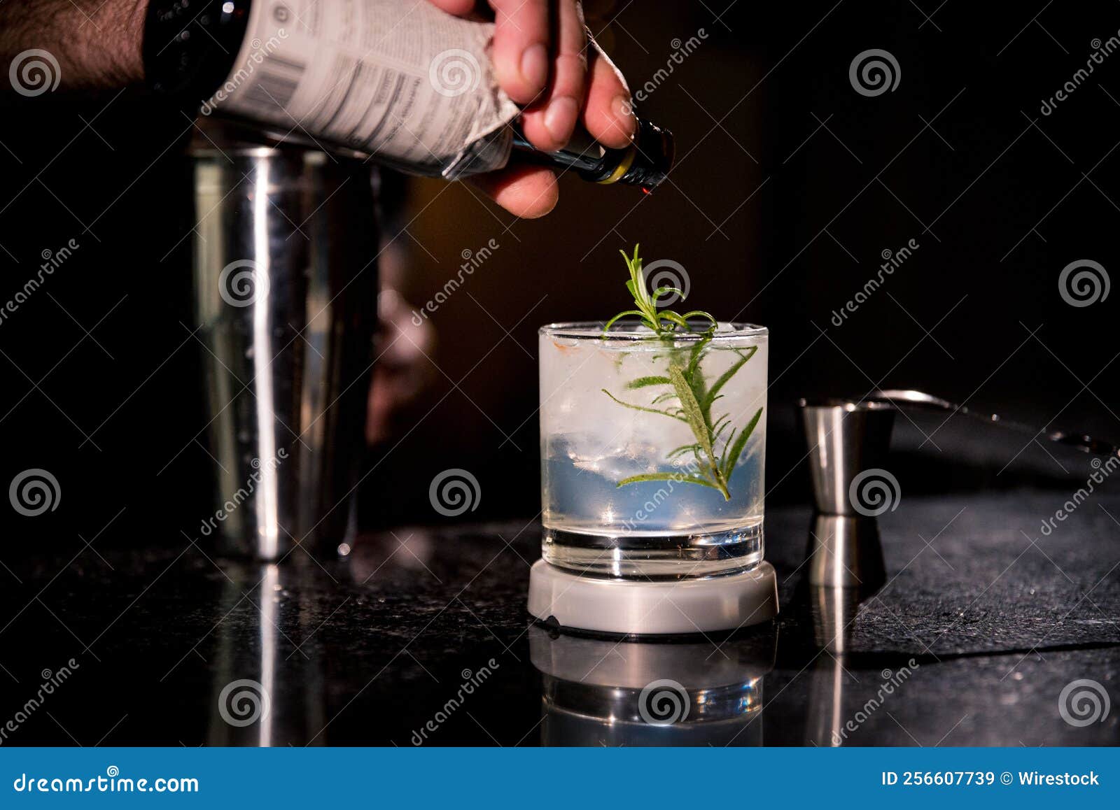 Bartender Pouring Gin into an Exotic, Fresh Cocktail with a Minty Leaf ...