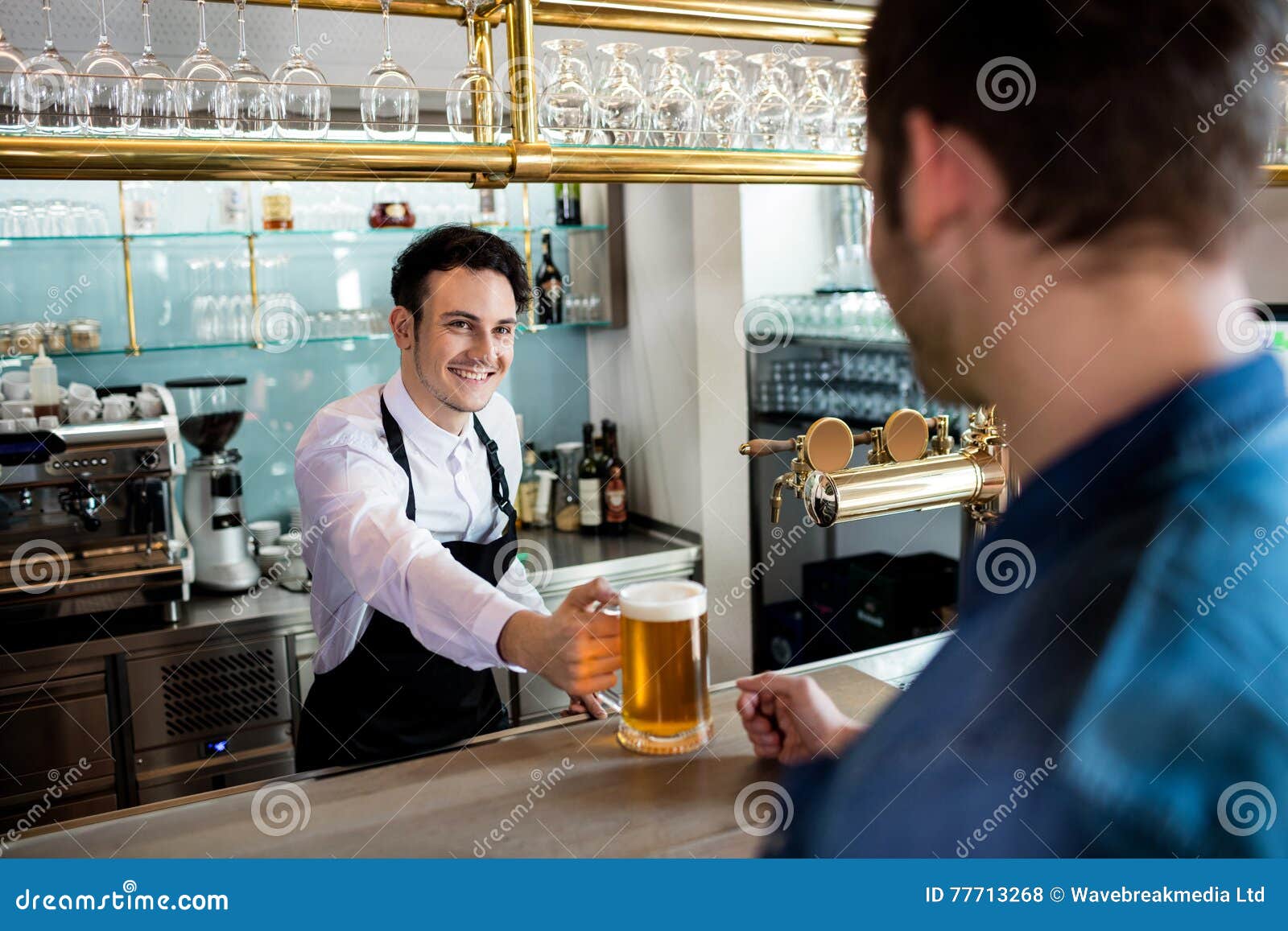 Bartender Serving Beer To Male Customer Stock Photo - Image of giving ...