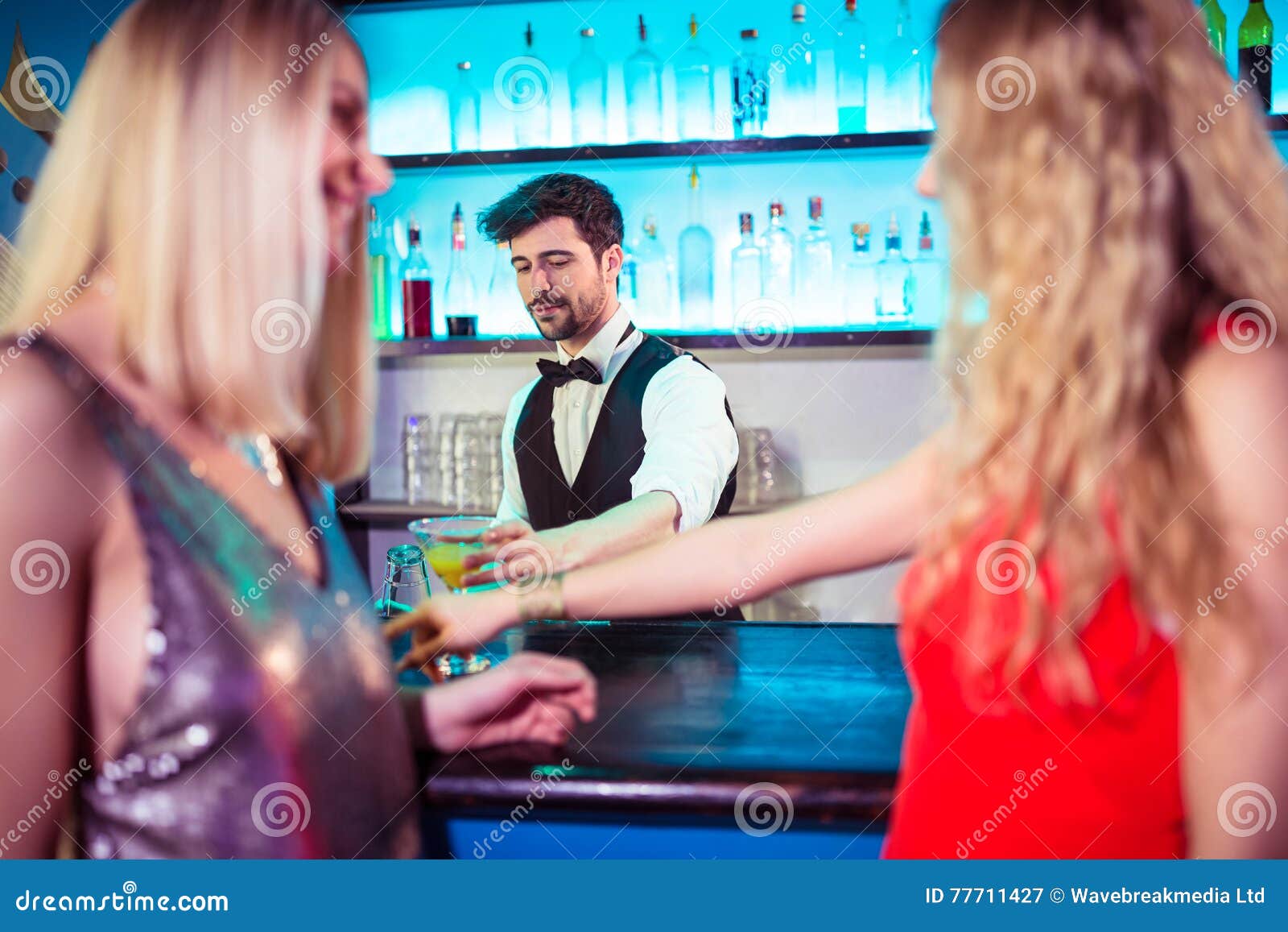 Bartender Serving Drinks To Female Customers Stock Image - Image of ...