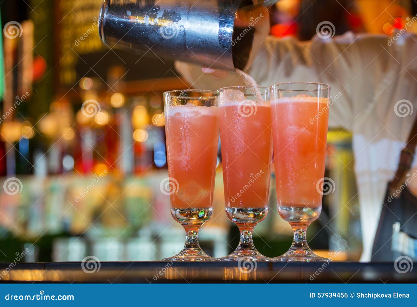 Bartender spills cocktails stock photo. Image of bottle - 57939456