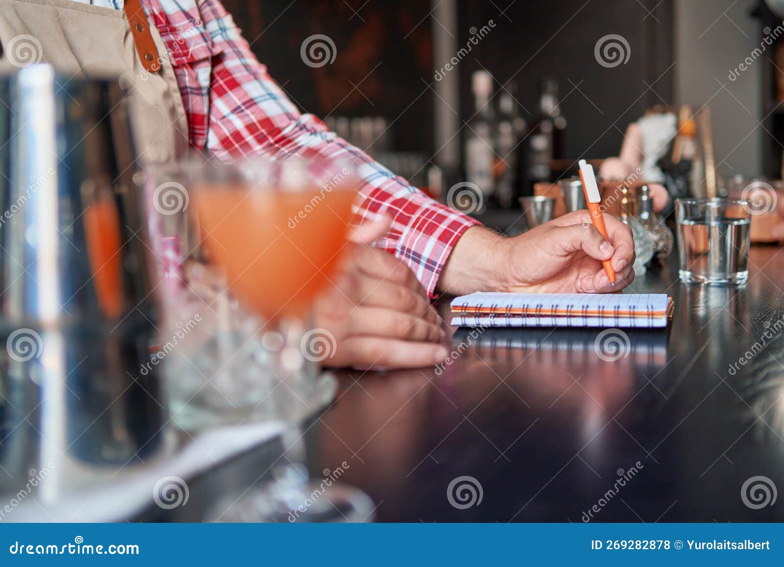 Bartender Standing at Bar Counter Taking Notes Stock Photo - Image of ...