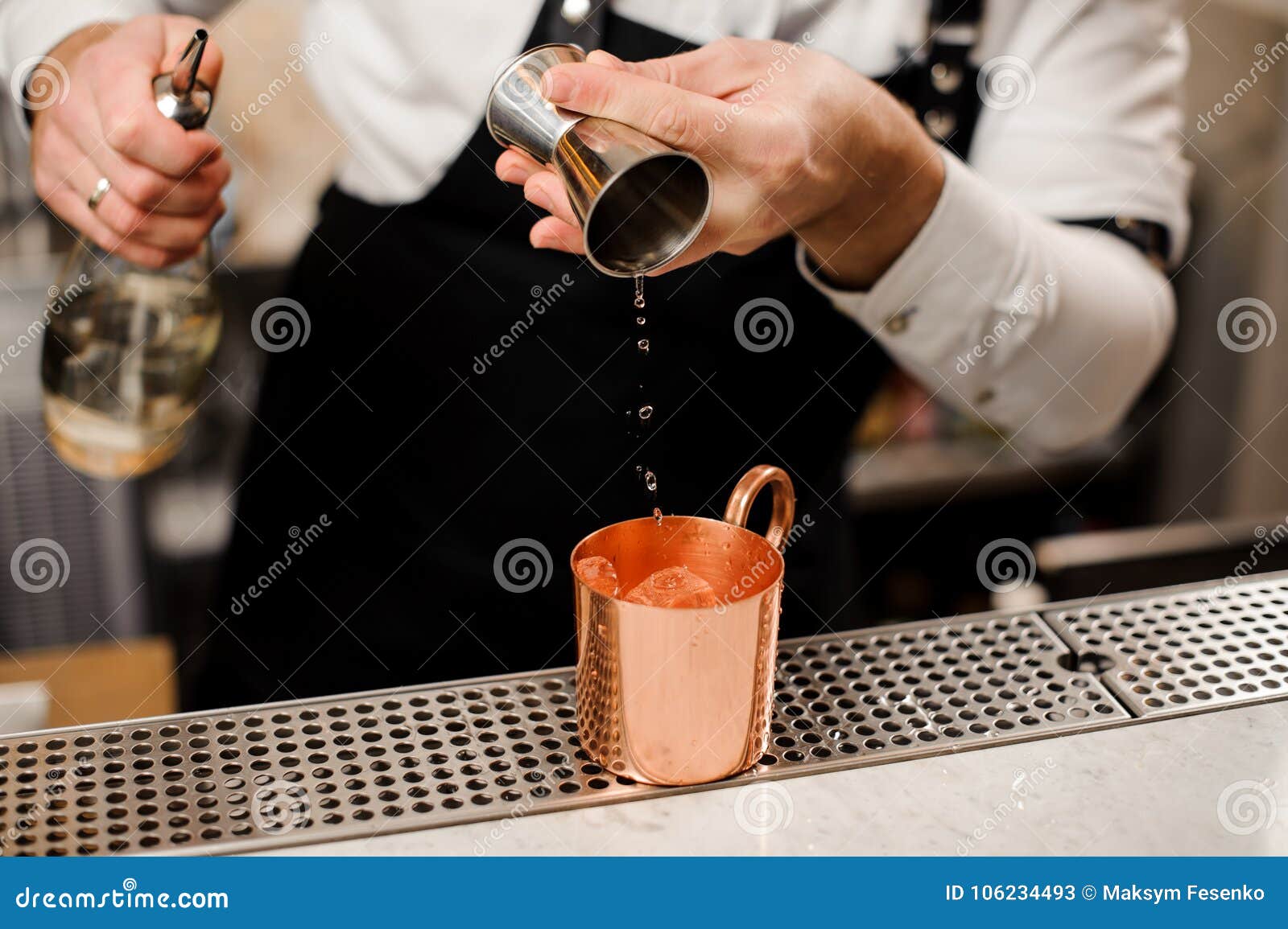 Bartenders Hand Pouring a Portion of Alcoholic Drink into the Cup Stock ...
