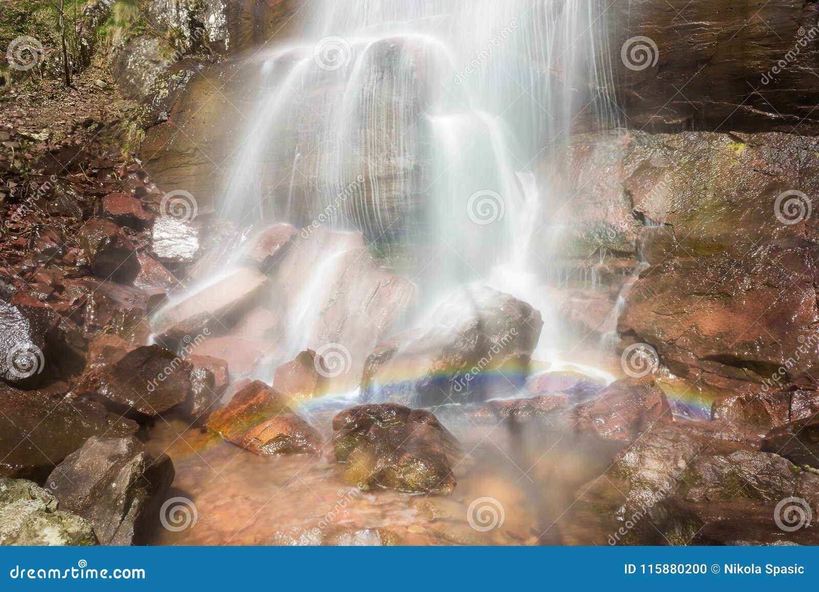 Base of a Powerful Waterfall Splashing on the Rock Creating a Rainbow ...