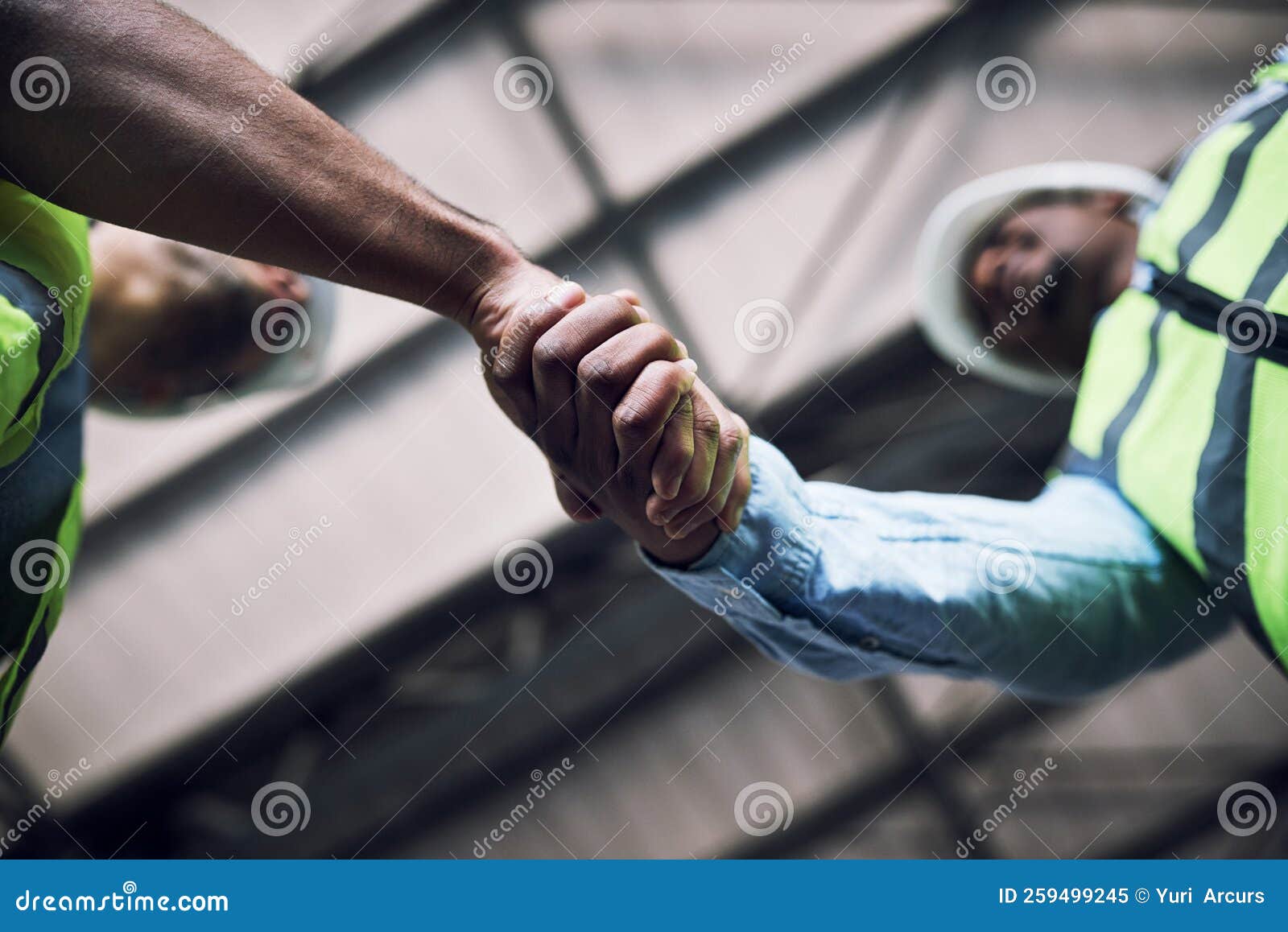 At the Base of Progress is Teamwork. Two Builders Shaking Hands at a ...