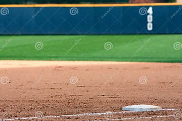 Baseball Field Shows First Base and Outfield Wall Stock Image - Image ...