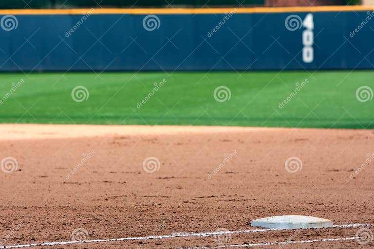 Baseball Field Shows First Base and Outfield Wall Stock Image - Image ...