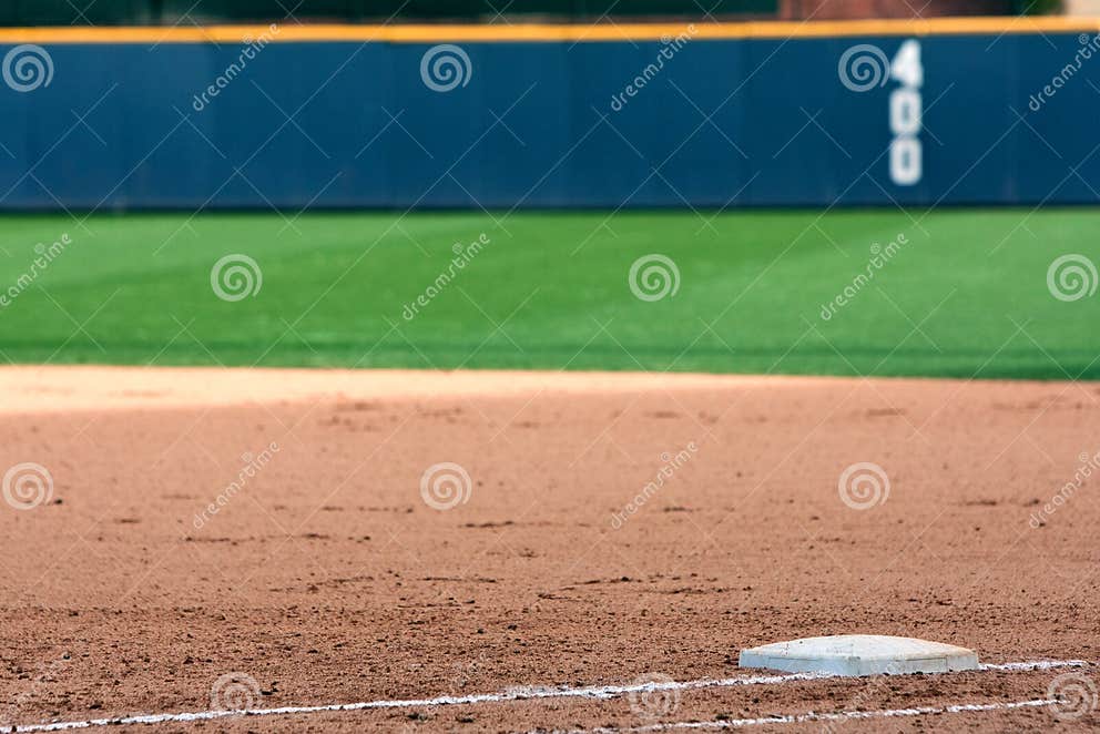 Baseball Field Shows First Base and Outfield Wall Stock Image - Image ...