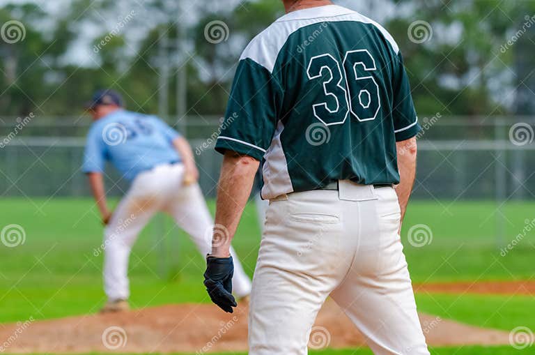 Baseball Game, Runner on the First Base is Watching the Pitcher and ...