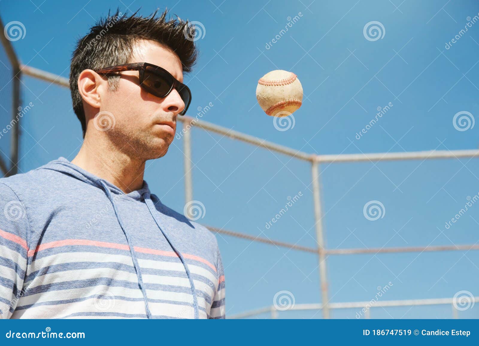 Baseball Player Looking at Ball Stock Image - Image of summer, casual ...