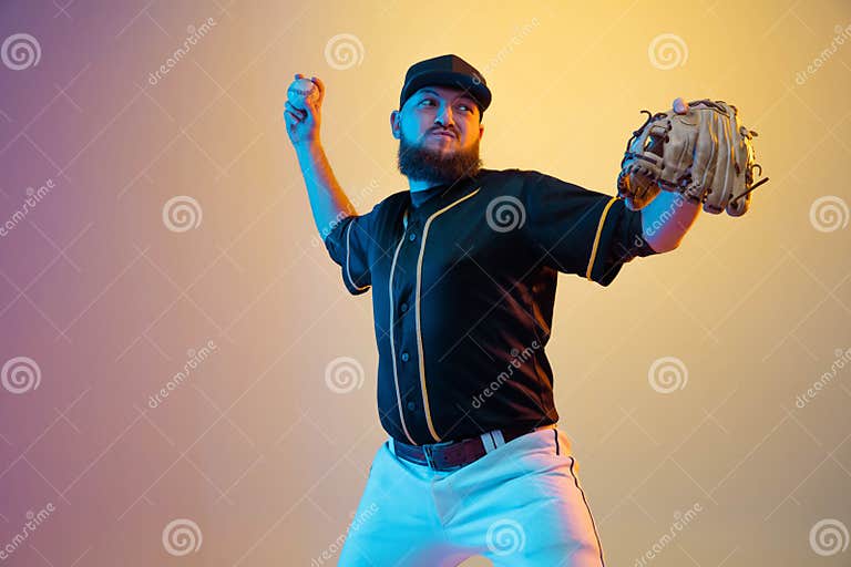 Baseball Player, Pitcher in a Black Uniform Practicing on Gradient ...