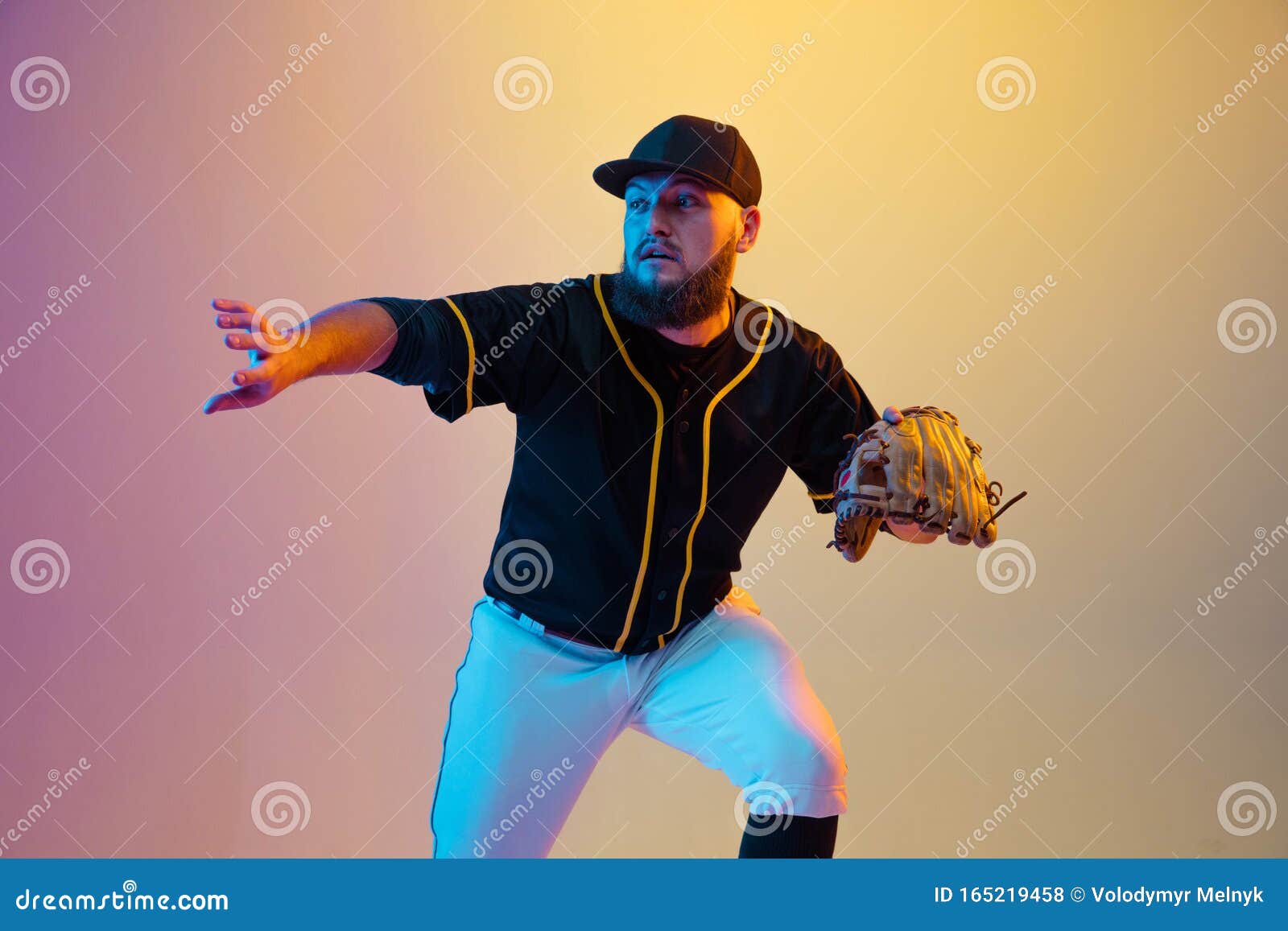 Baseball Player, Pitcher in a Black Uniform Practicing on Gradient ...