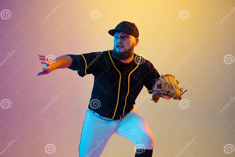 Baseball Player, Pitcher in a Black Uniform Practicing on Gradient ...