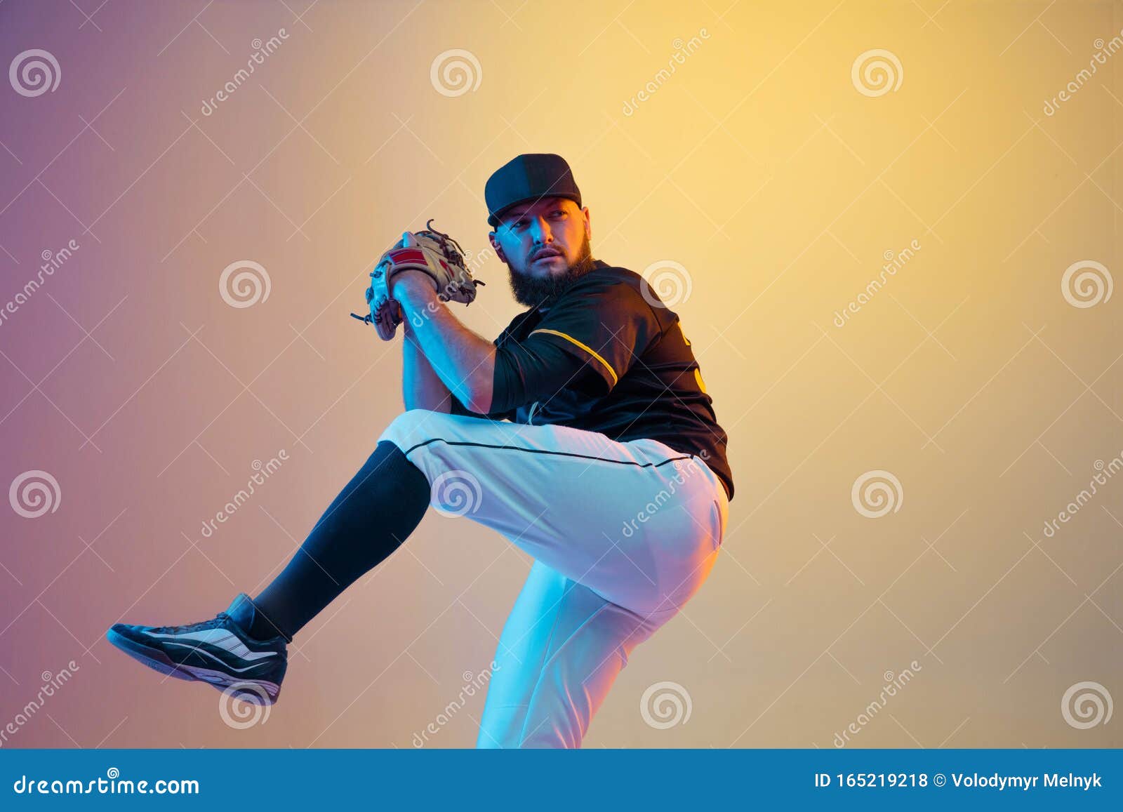 Baseball Player, Pitcher in a Black Uniform Practicing on Gradient ...
