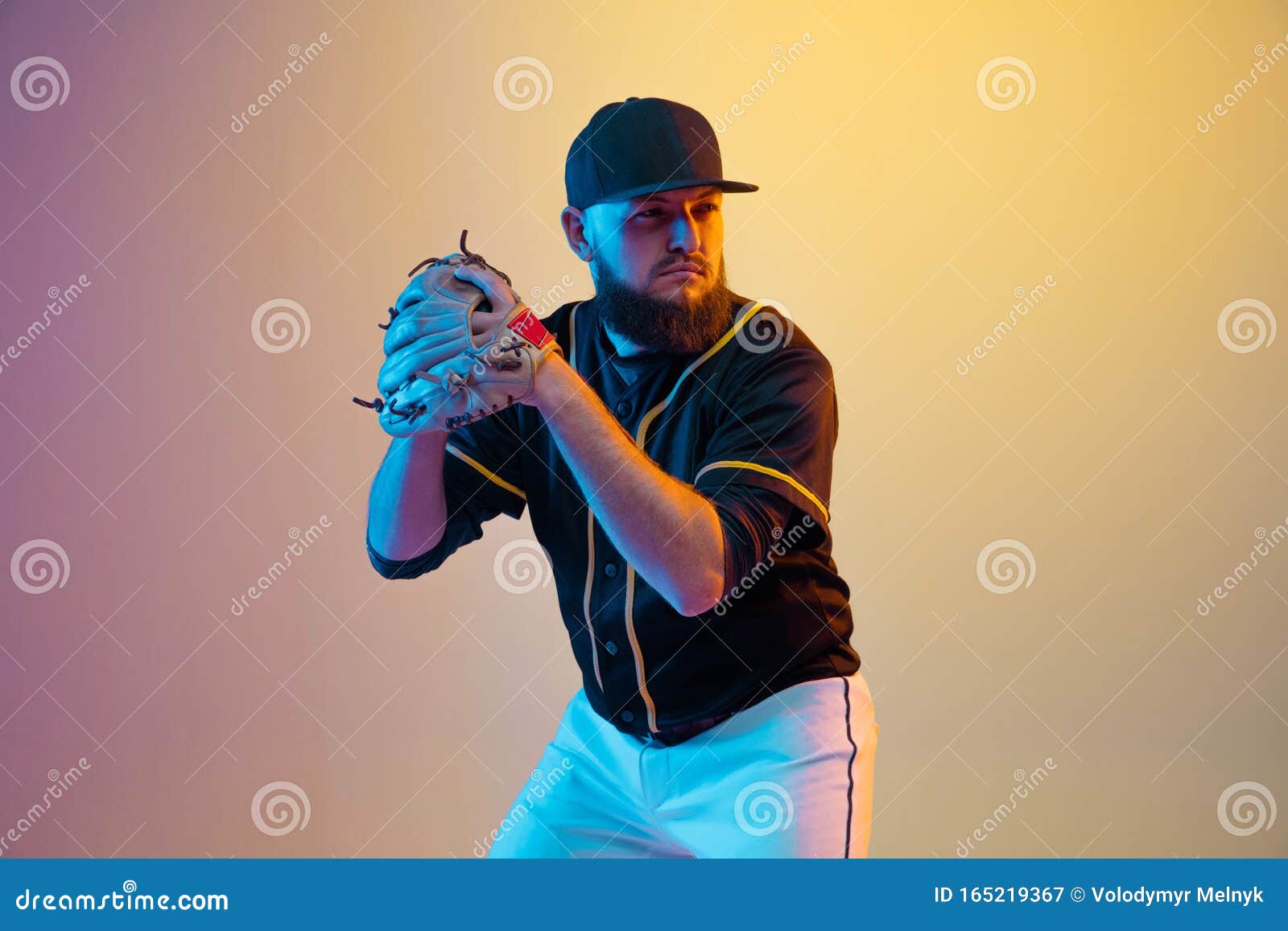 Baseball Player, Pitcher in a Black Uniform Practicing on Gradient ...