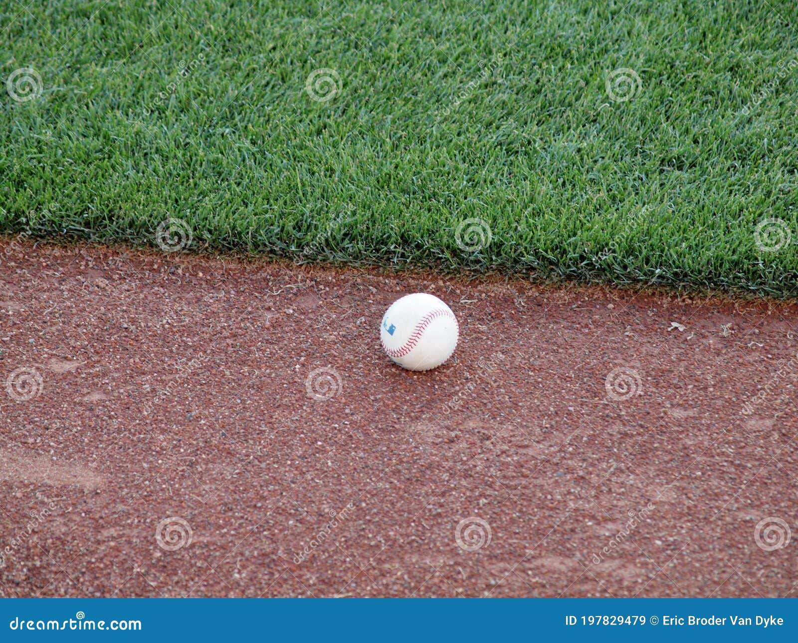 Baseball Rest on Edge of Warning Track Beyond the Outfield Grass ...