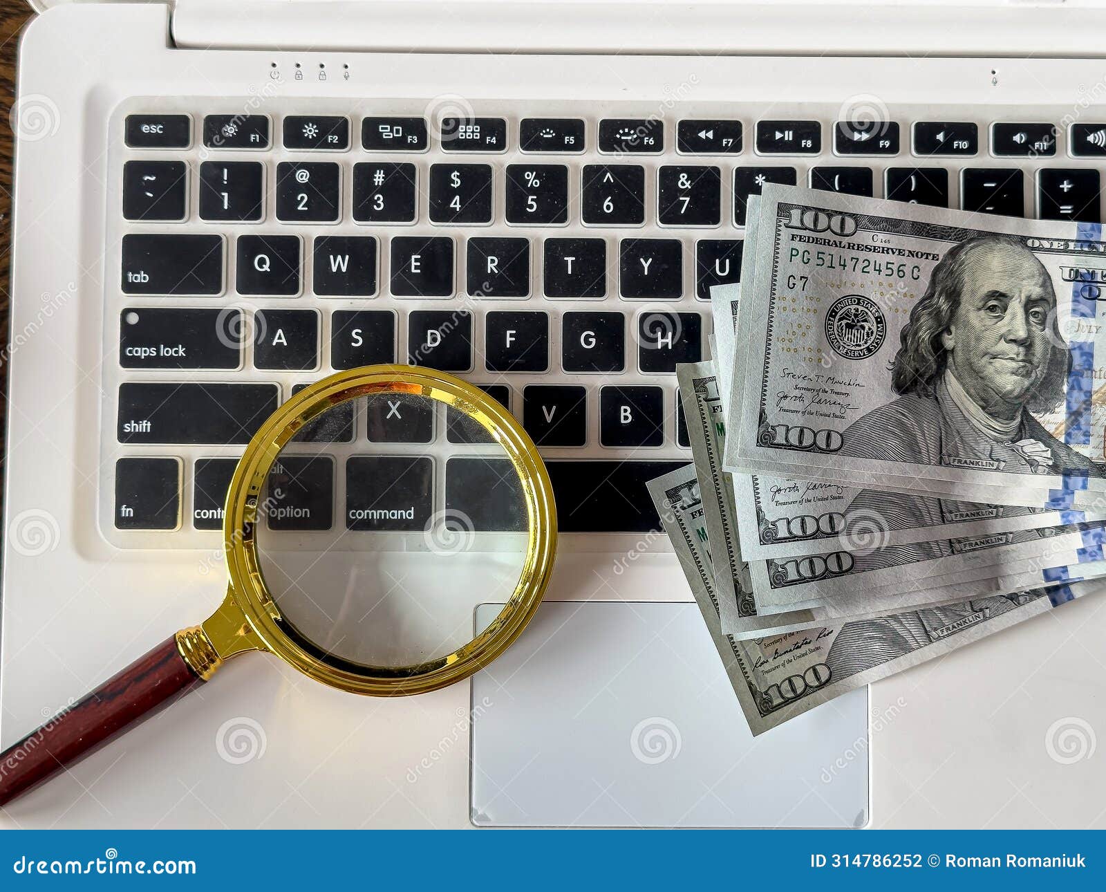 Basic Budgeting Tips with Magnifying Glass on Laptop with Us Dollar ...