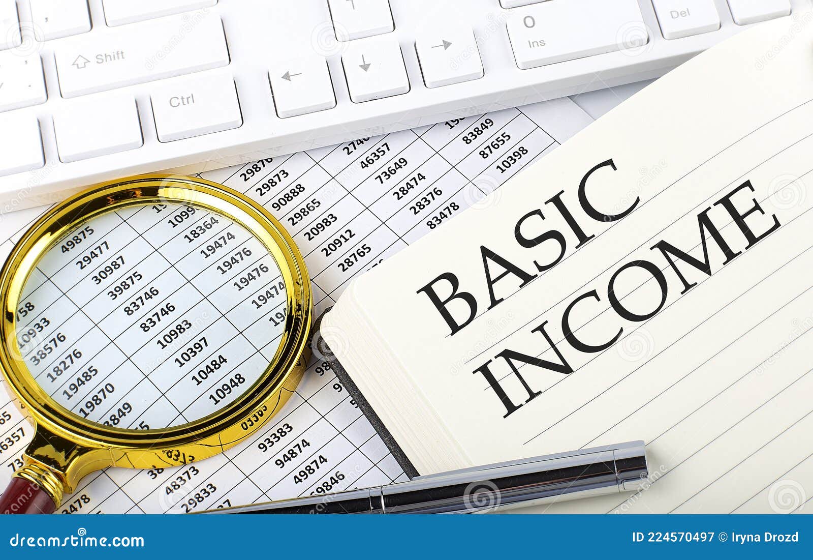 BASIC INCOME Text on Notebook with Chart, Magnifier,keyboard and Pen ...