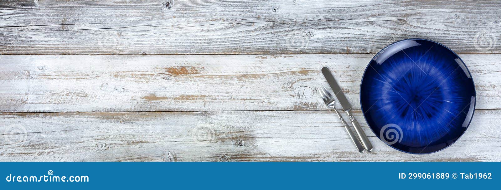 Basic Table Setting of an Empty Main Dark Blue Dish with Cutlery on ...